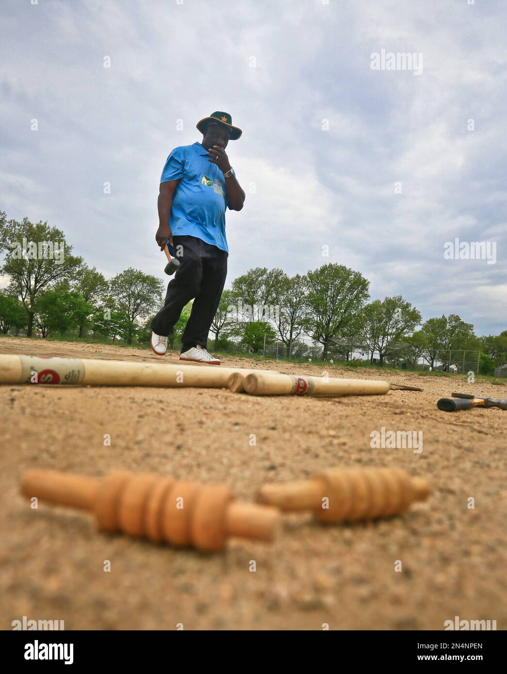 In this May 12, 2014 photo, cricket umpire Carl Whatley walks with a ...