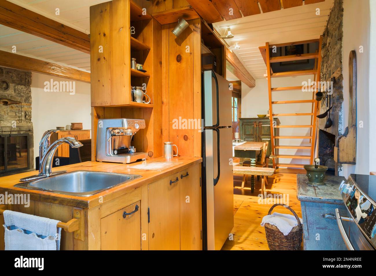 Small rustic kitchen with pine wood countertop, sink cabinet and ...