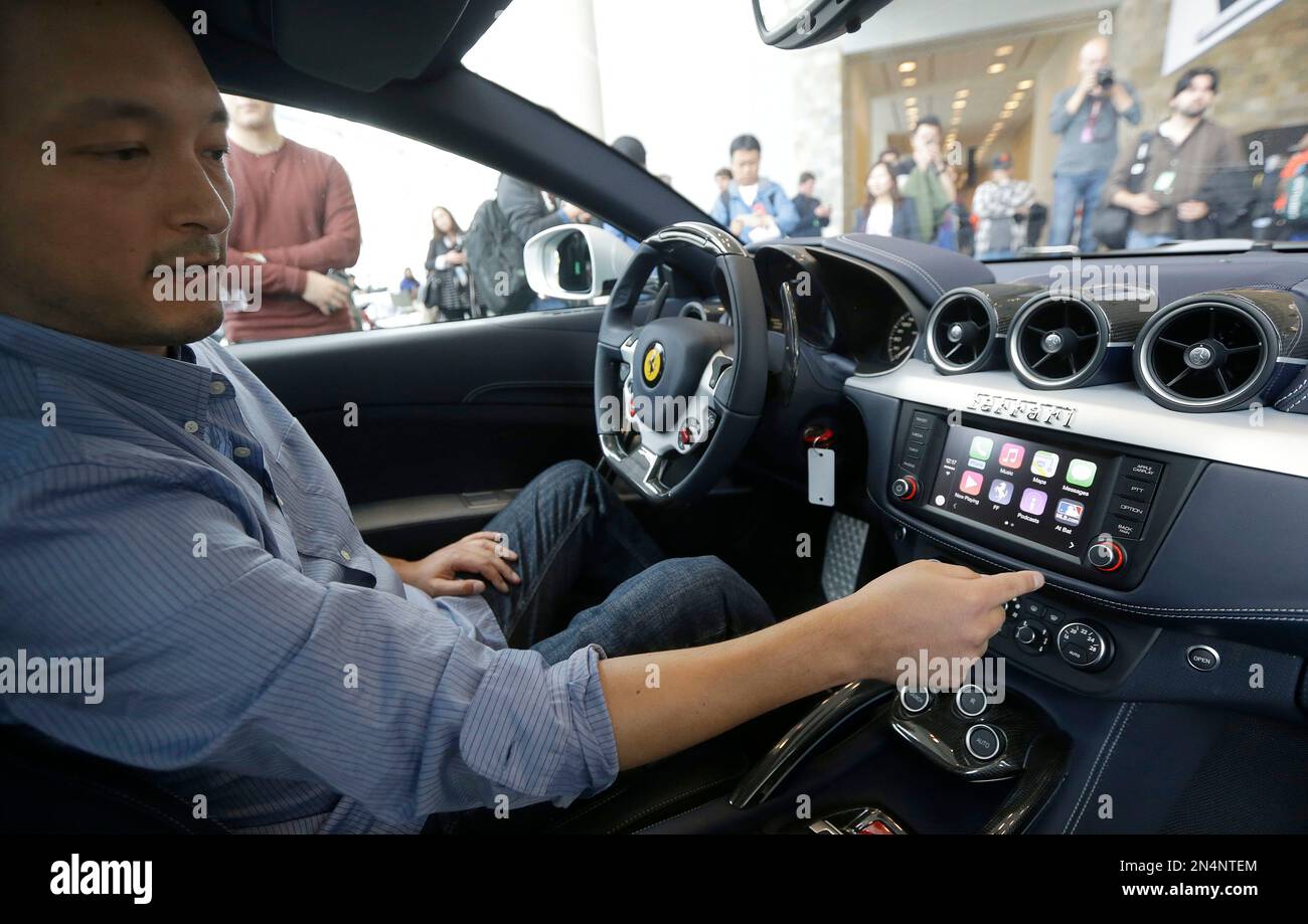 Stephen Chick with Apple gives a demonstration of CarPlay in a Ferrari ...
