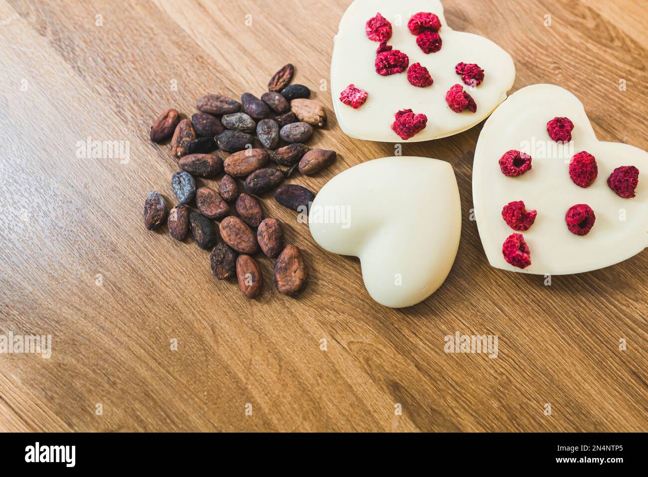 Craft white chocolate hearts with dried raspberry and cocoa beans. High ...