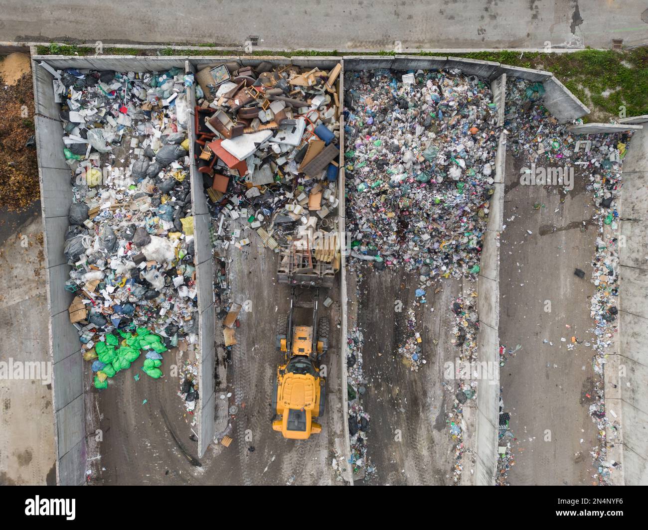Wheel loader on the landfill site, pushing, scooping and carrying waste ...