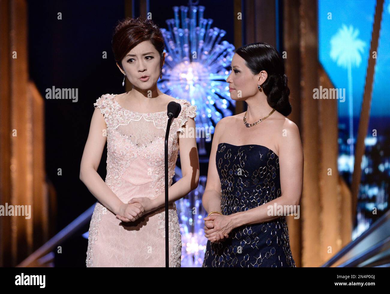 Co-hosts Olivia Xu, left, and Lucy Liu speak on stage at the Huading ...