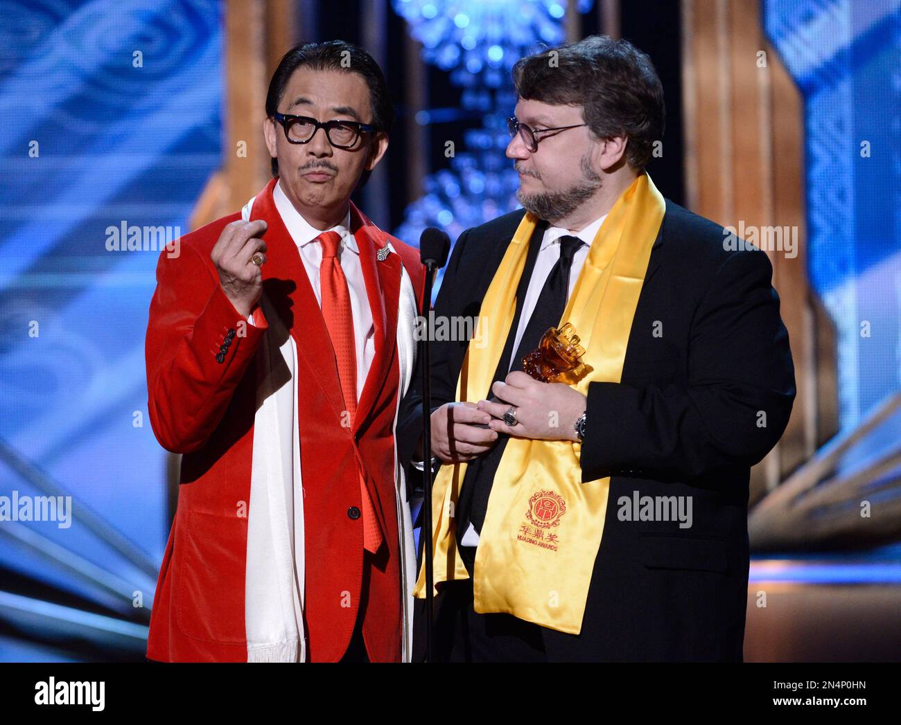 George Cheung, left, presents Guillermo del Toro with the award for ...