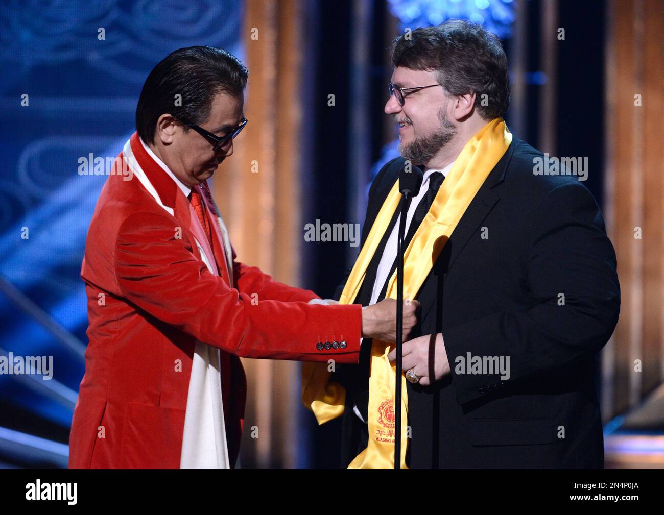 George Cheung, left, presents Guillermo del Toro with the award for ...