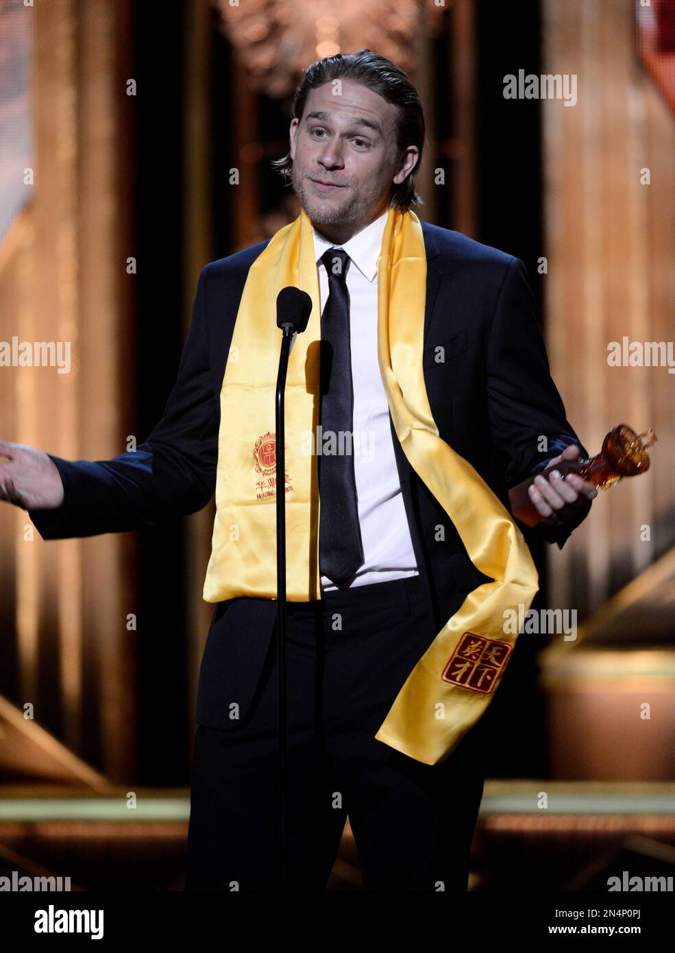 Charlie Hunnam accepts the best global emerging actor award on stage at ...