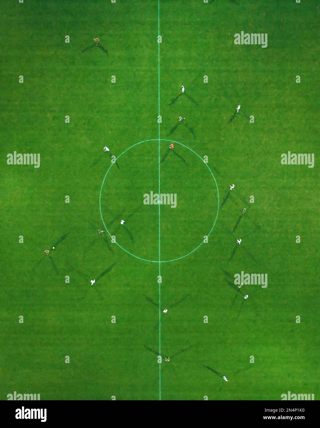 An aerial top view of competitive athletes playing soccer in a turf ...