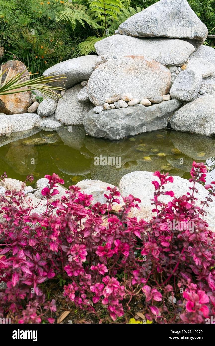 Beautiful Garden Design With Stones And Lake Stock Photo - Alamy