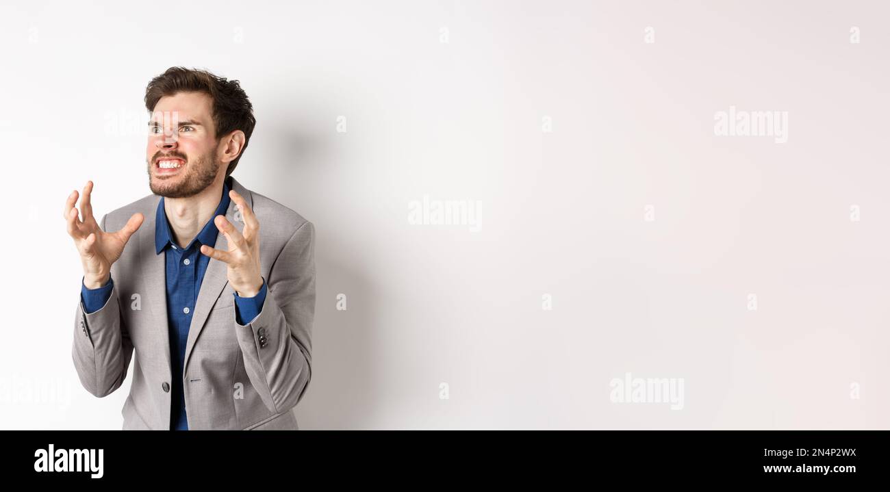 Angry man in business suit look left with hatred, stare aside and ...