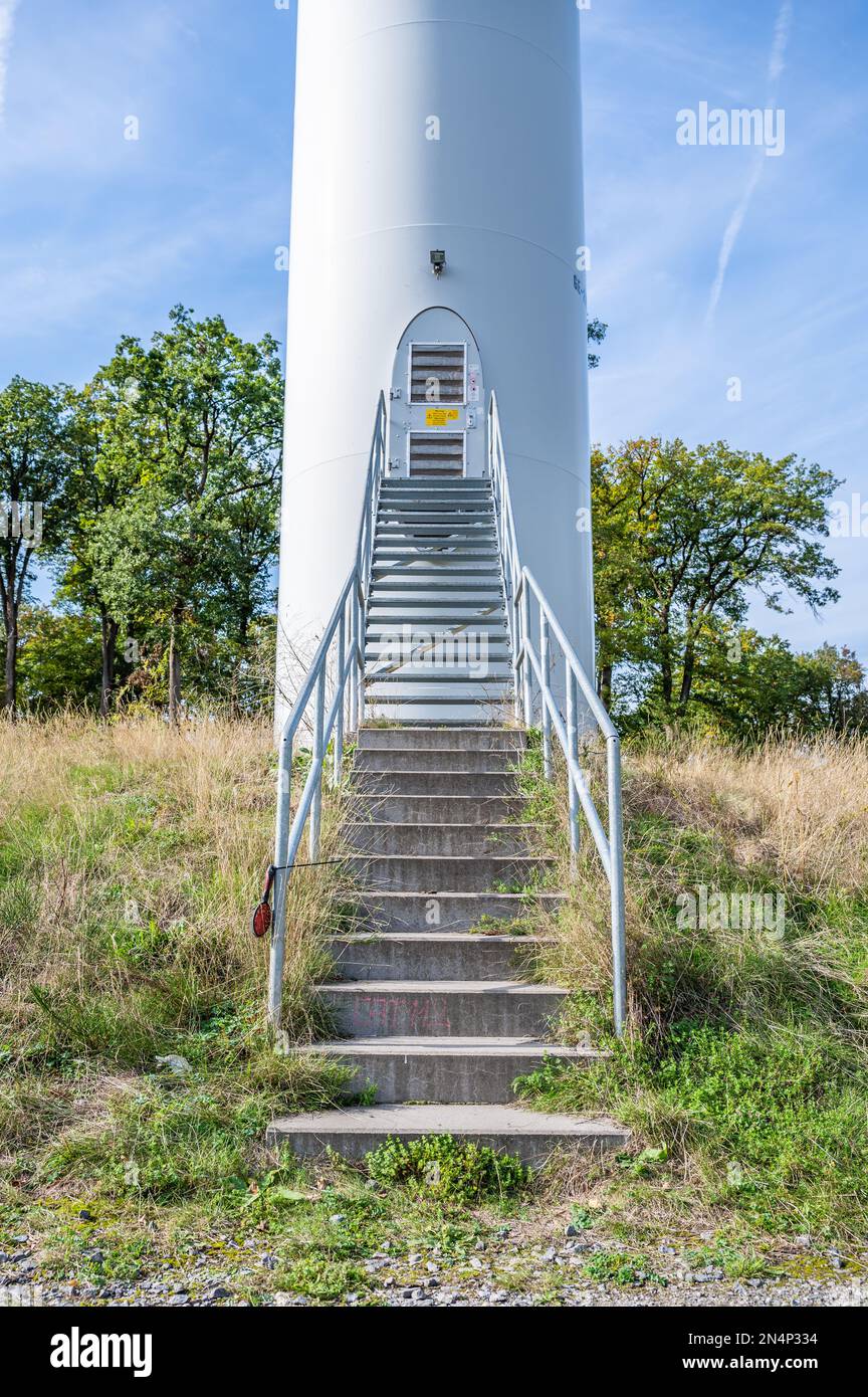 Modern wind tubine with stairs and entrance in the middle of the forest ...