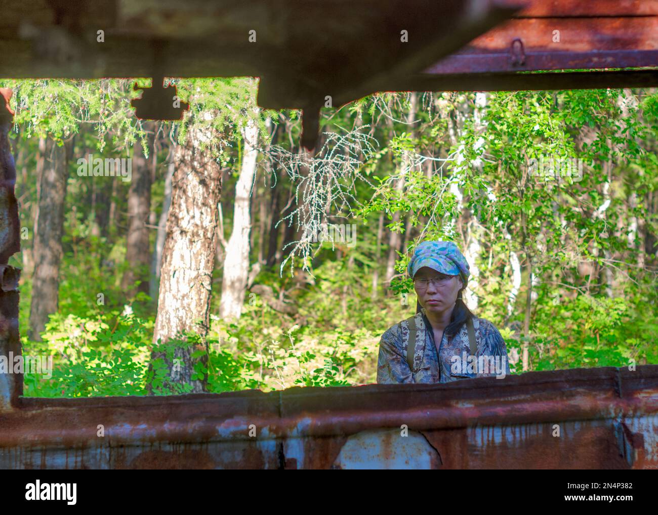 Sad thoughtful Yakut Asian girl tourist with glasses looking at the ...