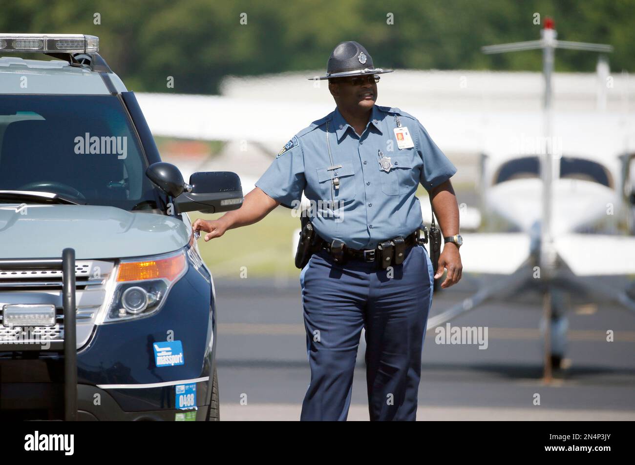 A Massachusetts state police officer stands guard at an entry gate to ...