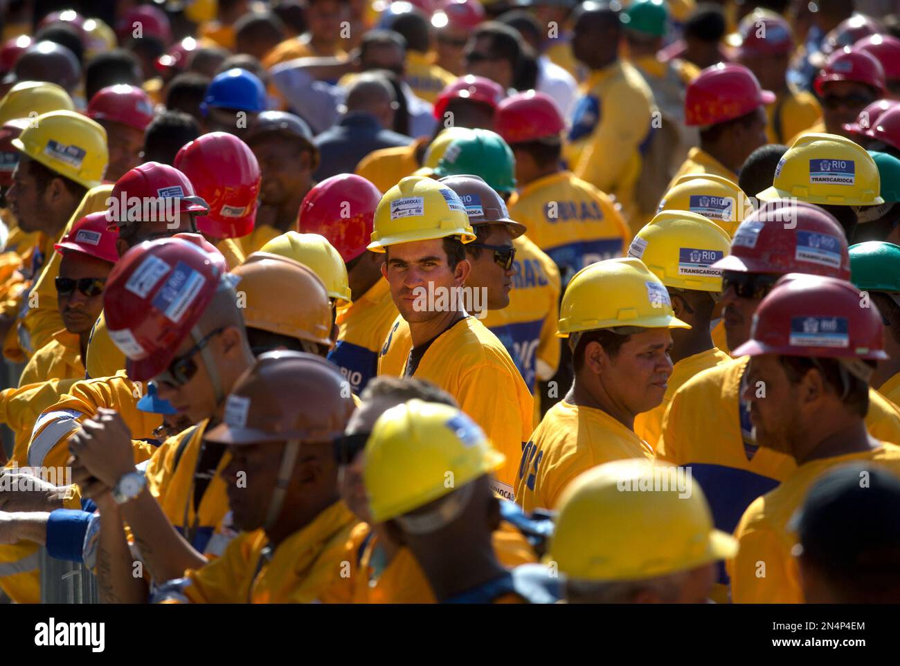 Workers attend the ceremony of the inauguration of the BRT Transcarioca ...