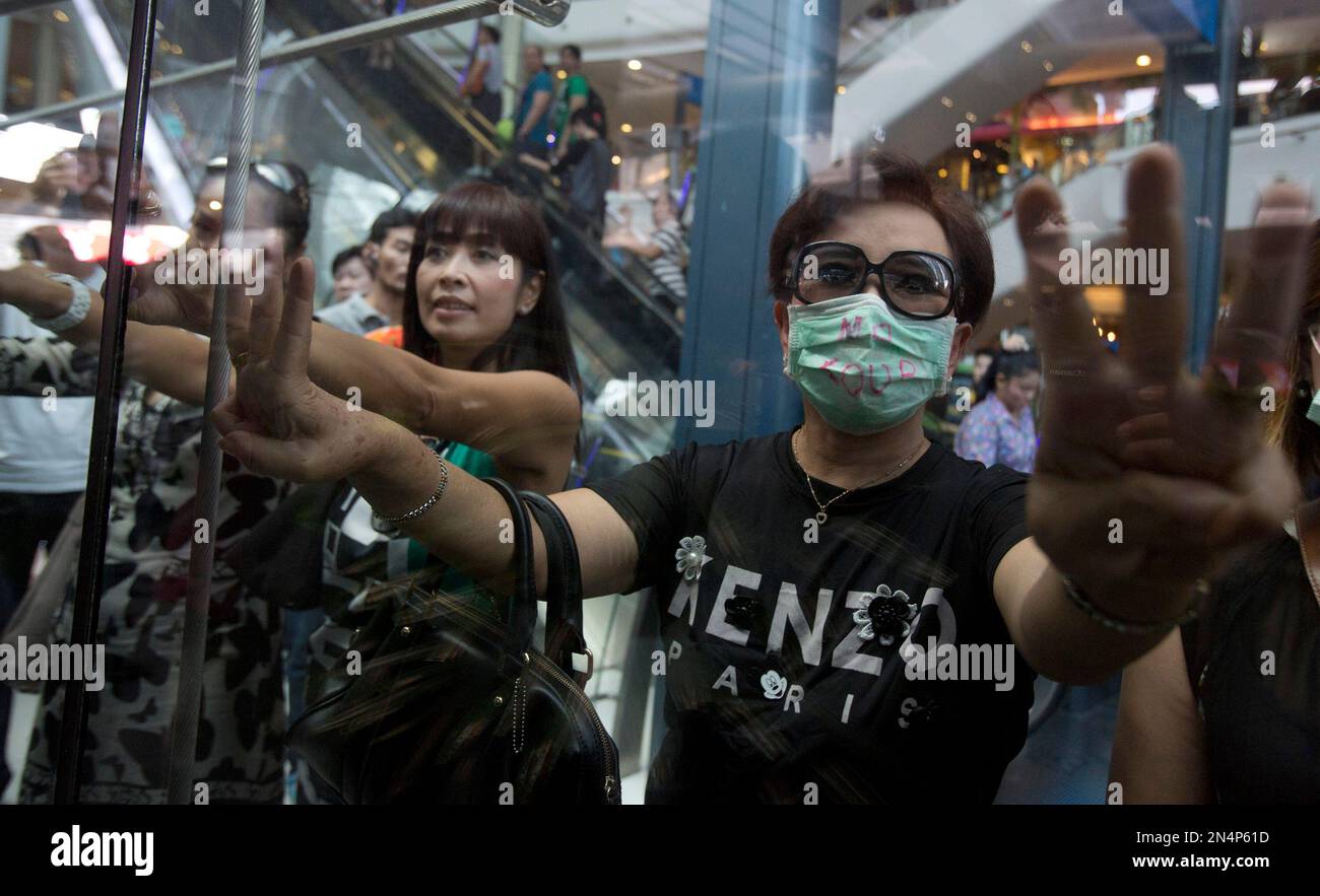 Protesters show three fingers representing liberty, brotherhood and ...
