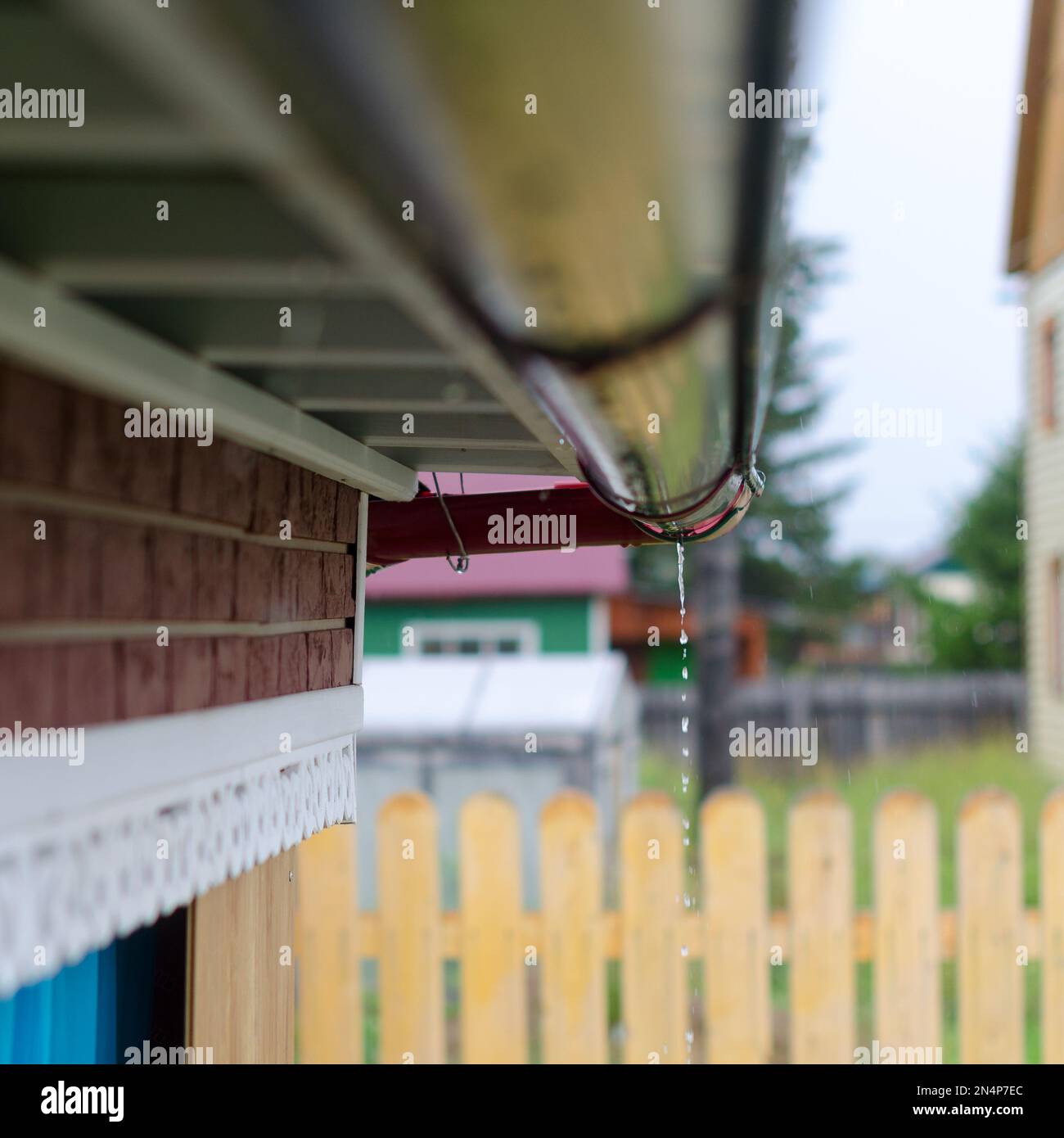 The bottom of the gutter under the edge of the roof in the new house of ...