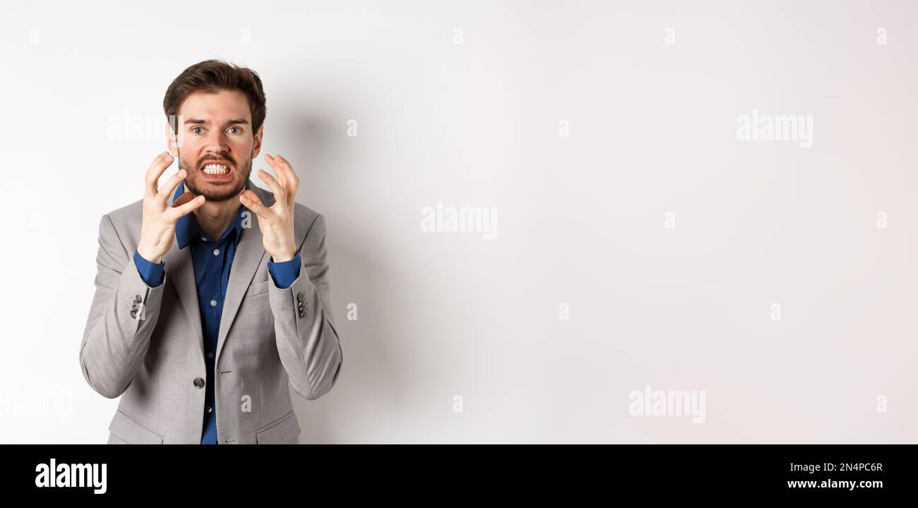 Angry and annoyed businessman wants to kill someone, clenching hands ...
