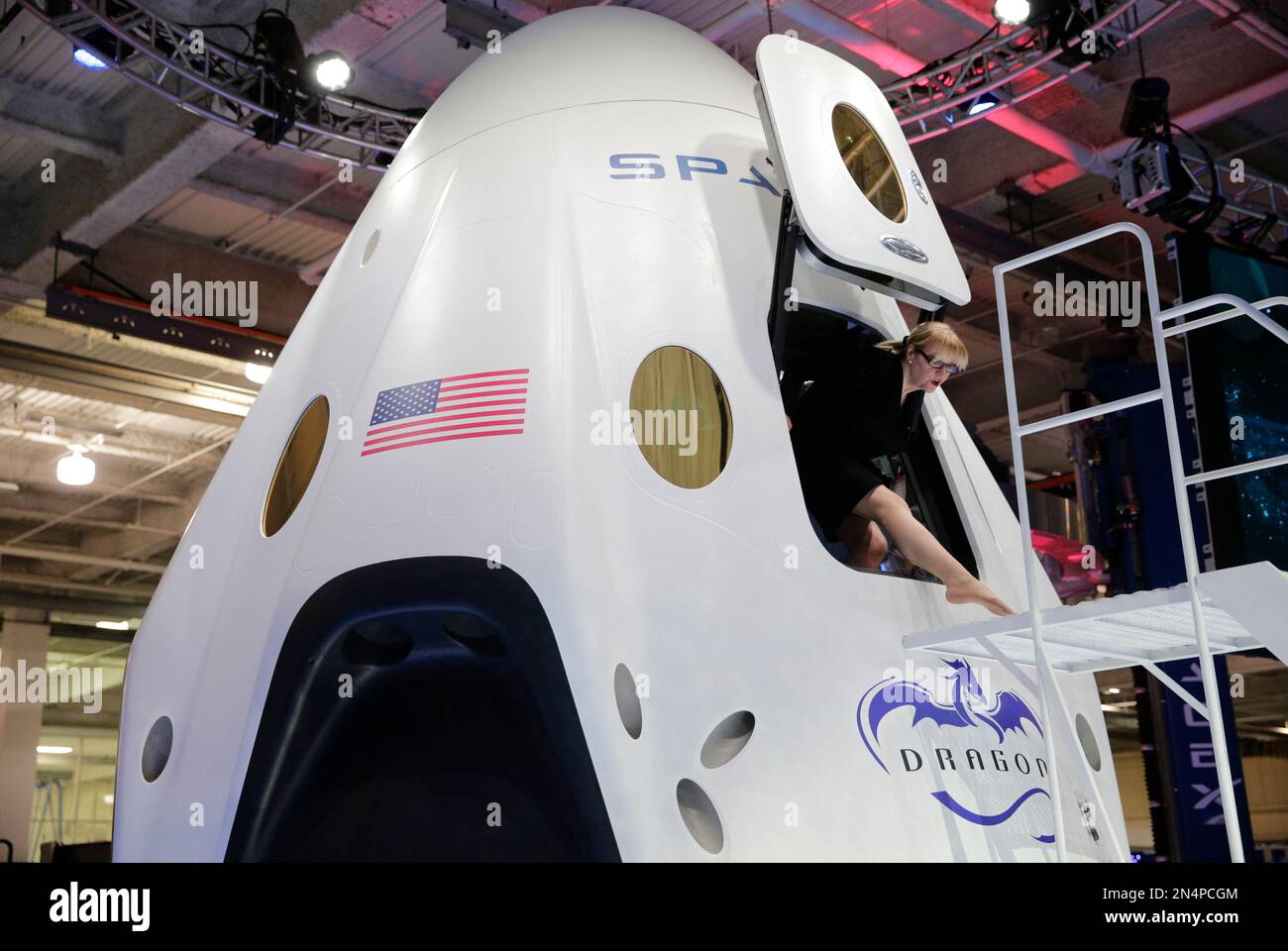 An invited guest walks out of the cabin of the SpaceX Dragon V2 ...