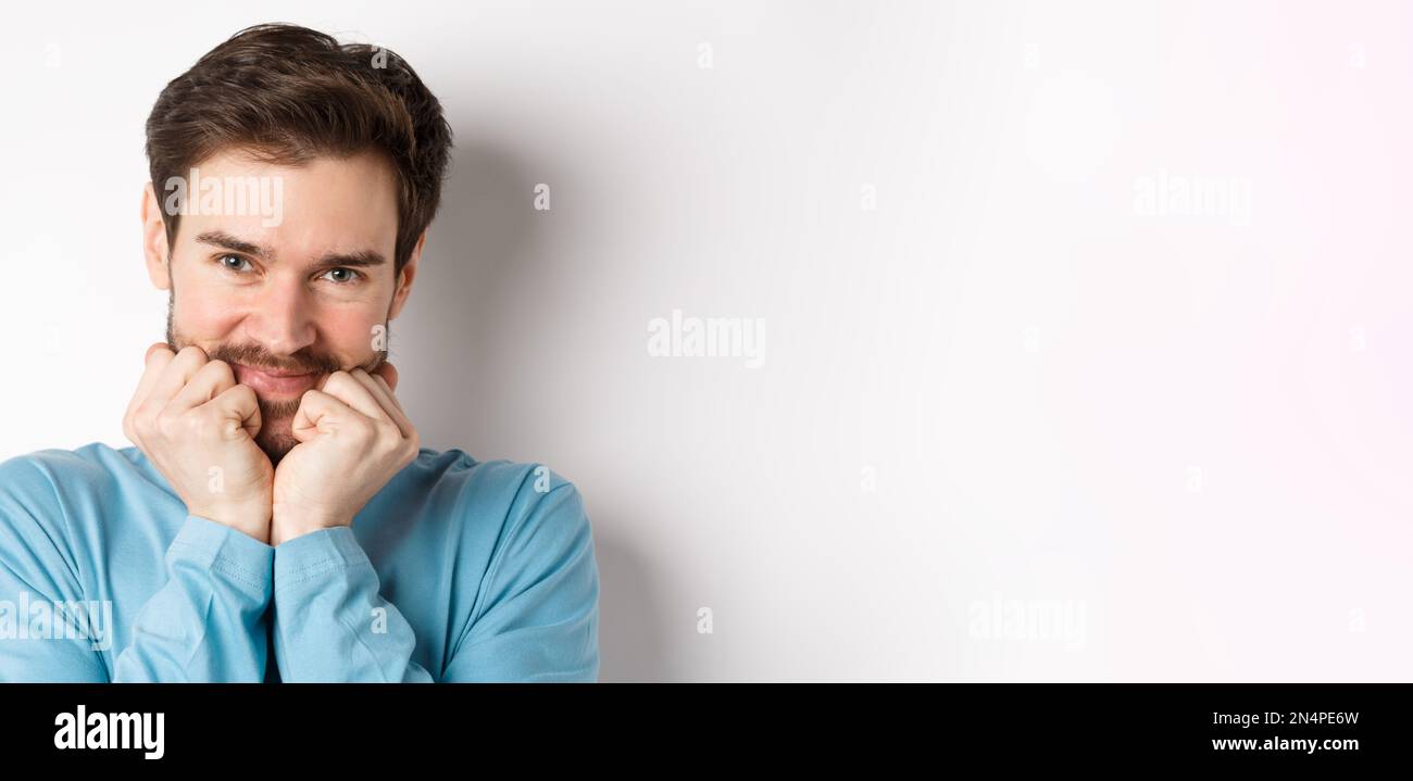 Cute caucasian man looking at something with admiration and desire ...