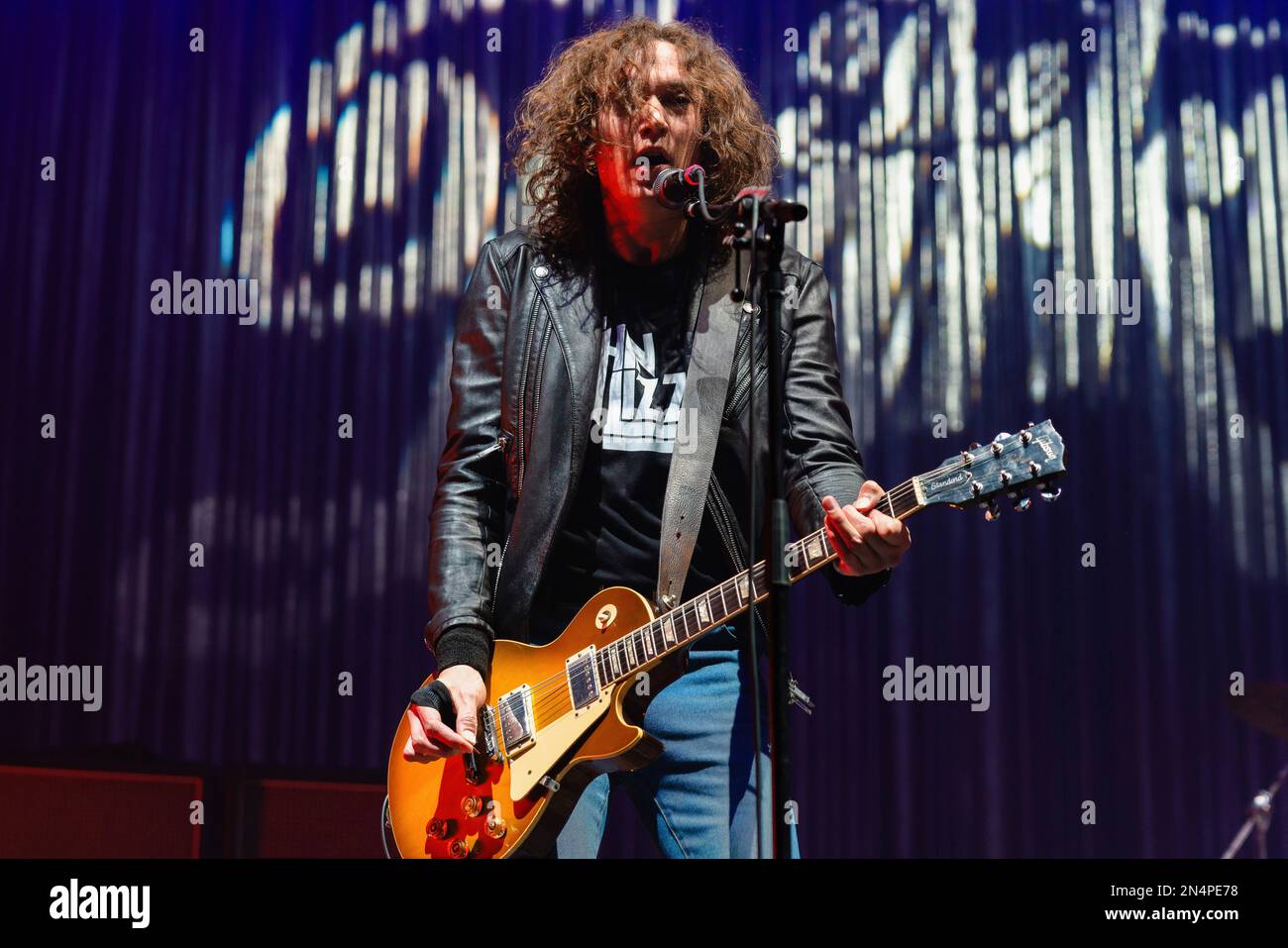 Dan Hawkins of the Darkness playing live on stage in leather jacket and ...