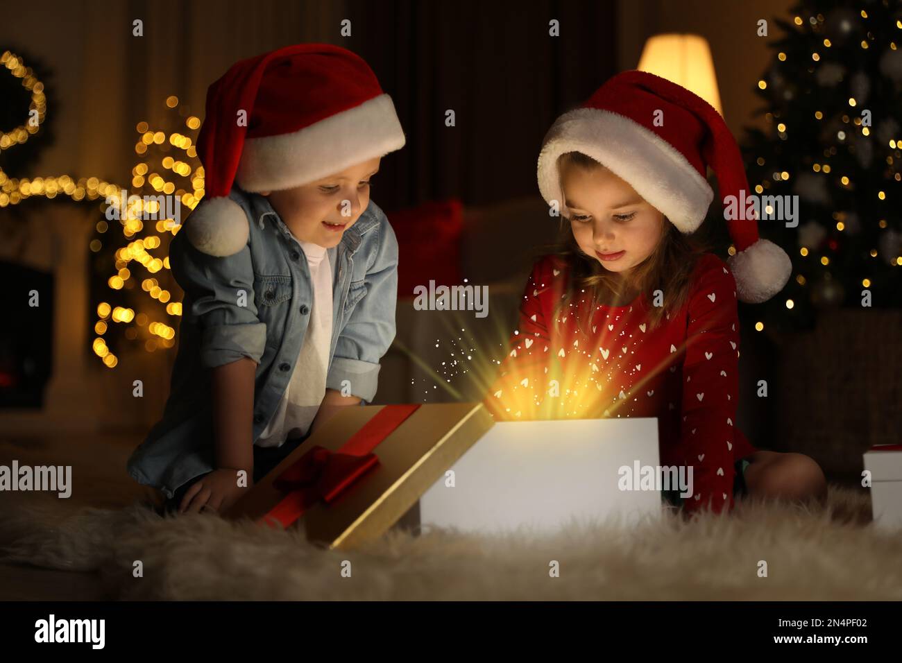 Children opening magic gift box hi-res stock photography and images - Alamy