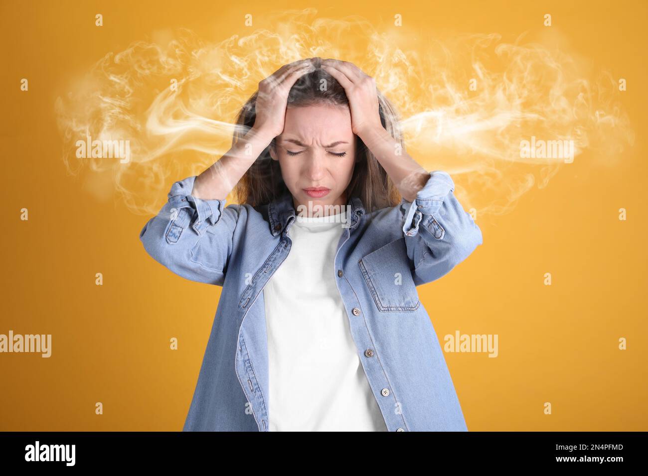 Stressed and upset young woman on yellow background Stock Photo - Alamy