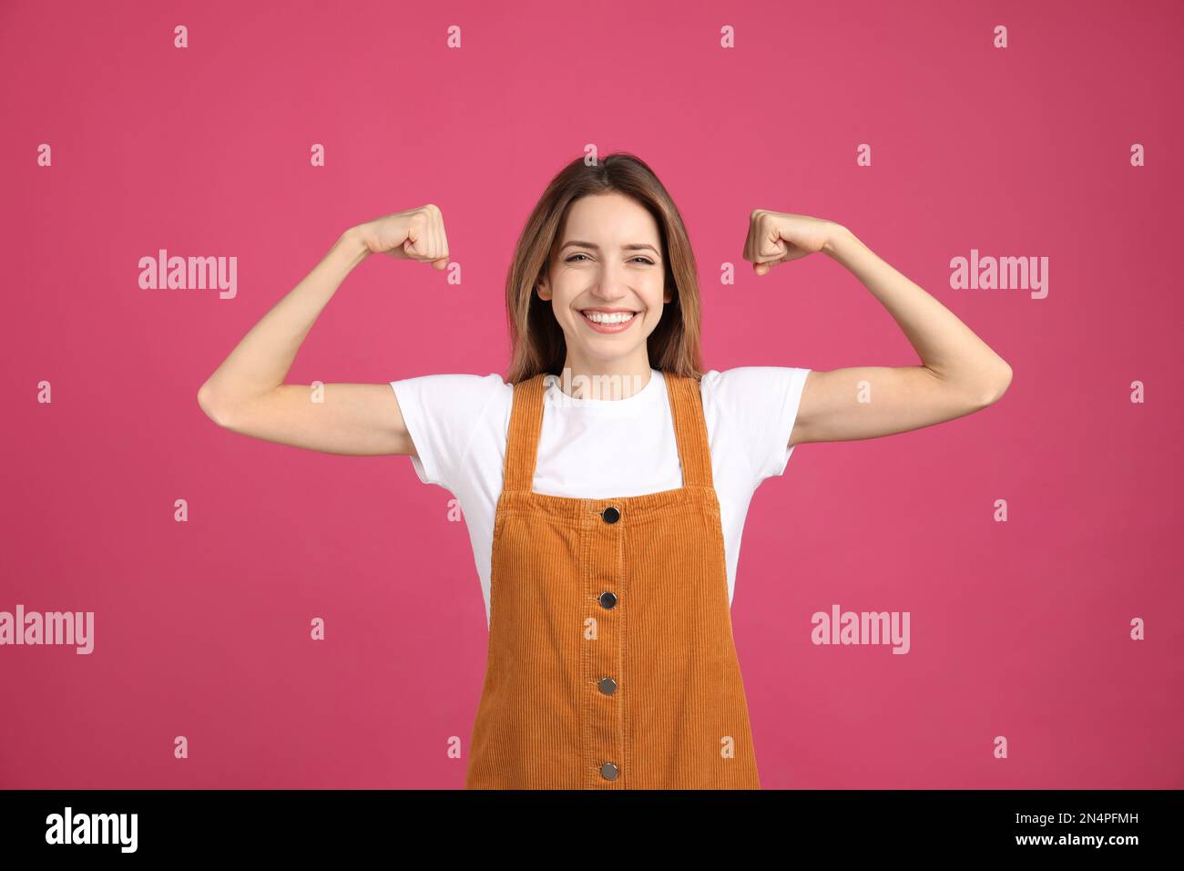 Strong woman as symbol of girl power on pink background. 8 March ...