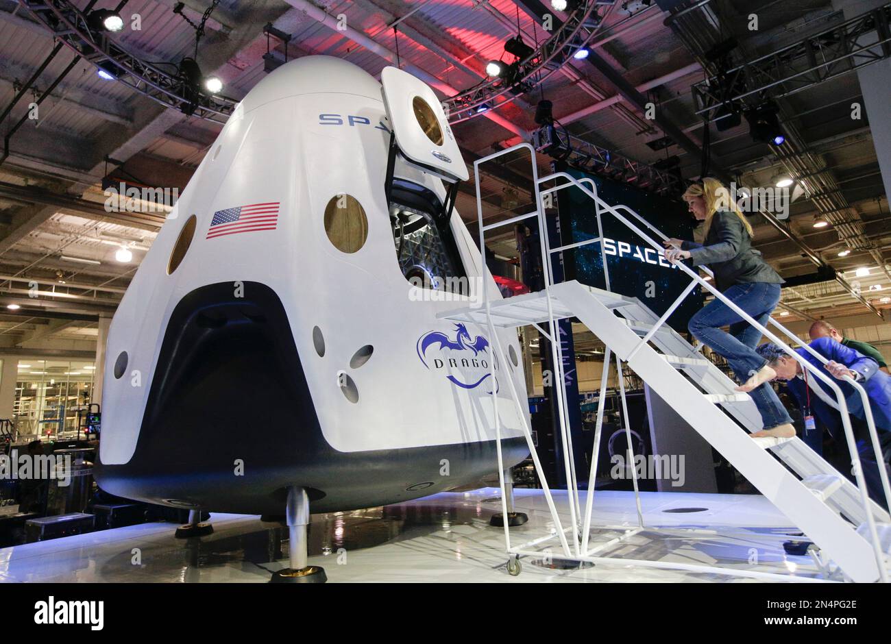 Invited guests walk up the steps to look at the inside of the SpaceX ...