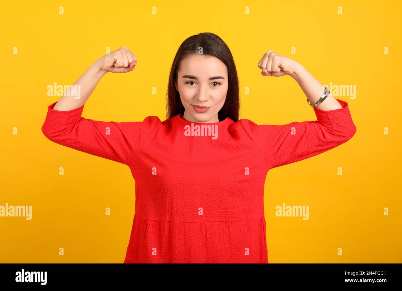Strong woman as symbol of girl power on yellow background. 8 March ...