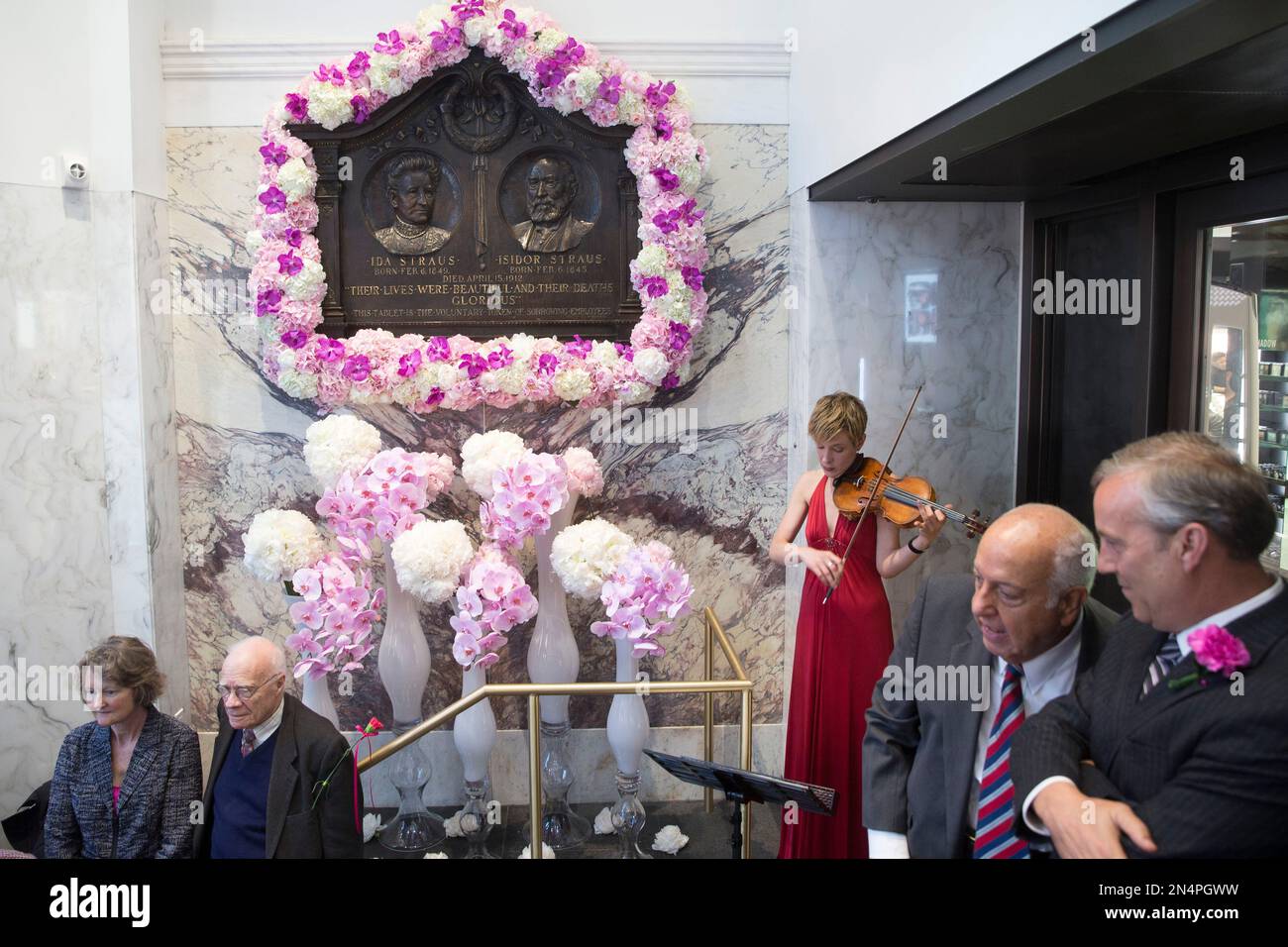 A violin player performs alongside the renovated Isidor and Ida Straus ...