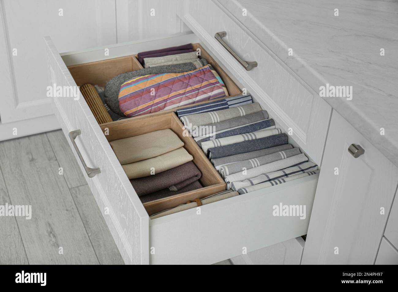 Open drawer with different textiles in kitchen Stock Photo - Alamy