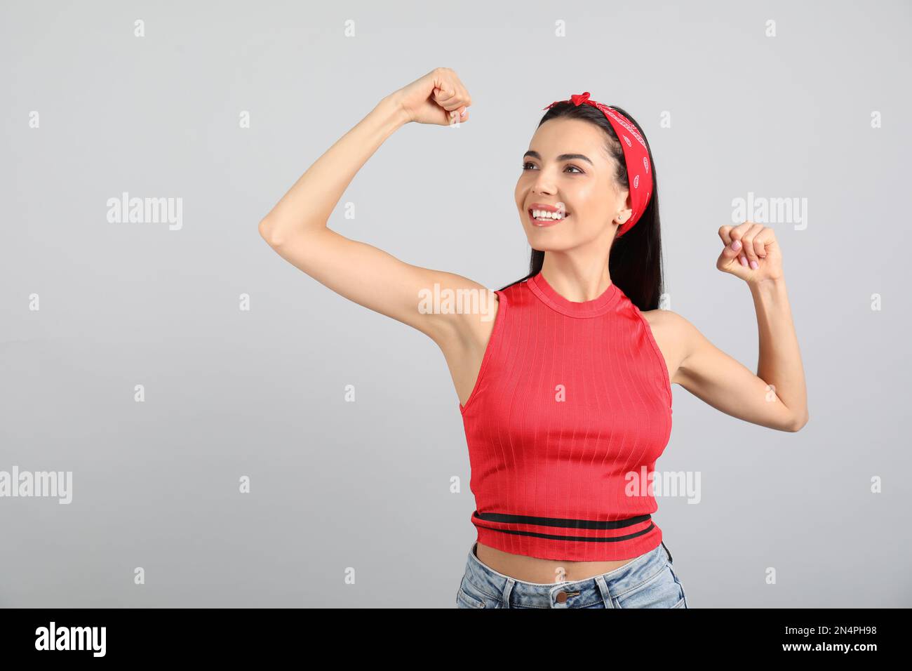 Strong woman as symbol of girl power on light grey background. 8 March ...