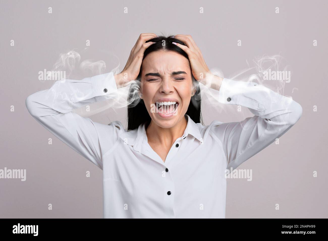 Stressed and upset young woman on light grey background Stock Photo - Alamy