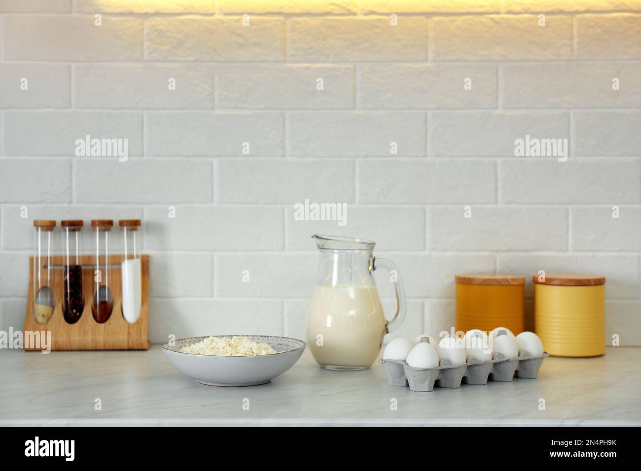 Different dairy products and eggs on countertop in modern kitchen Stock ...