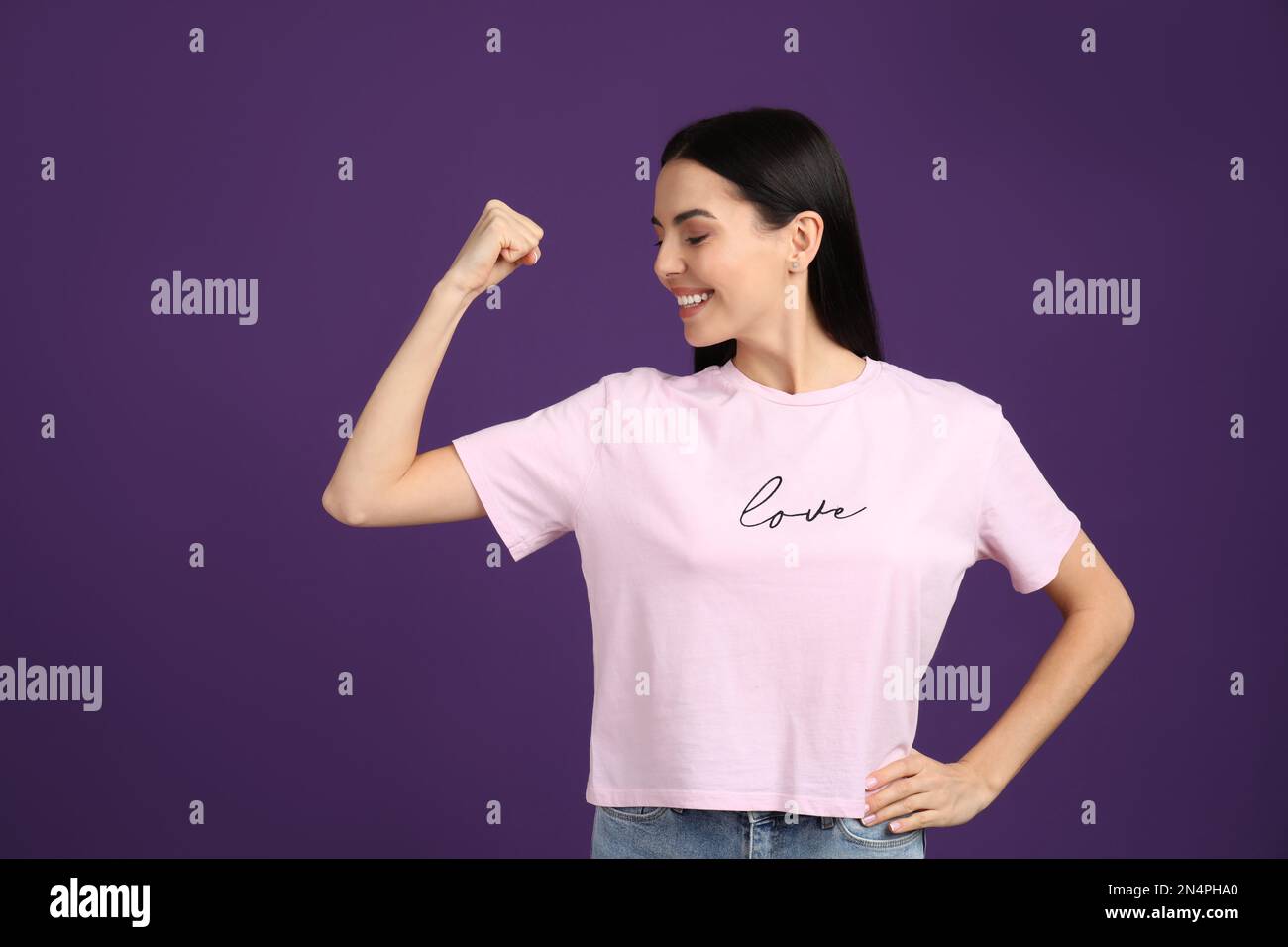 Strong woman as symbol of girl power on purple background. 8 March ...