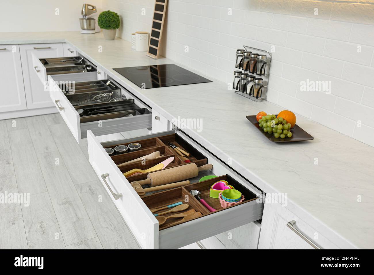 Open drawers with different utensils in kitchen Stock Photo - Alamy