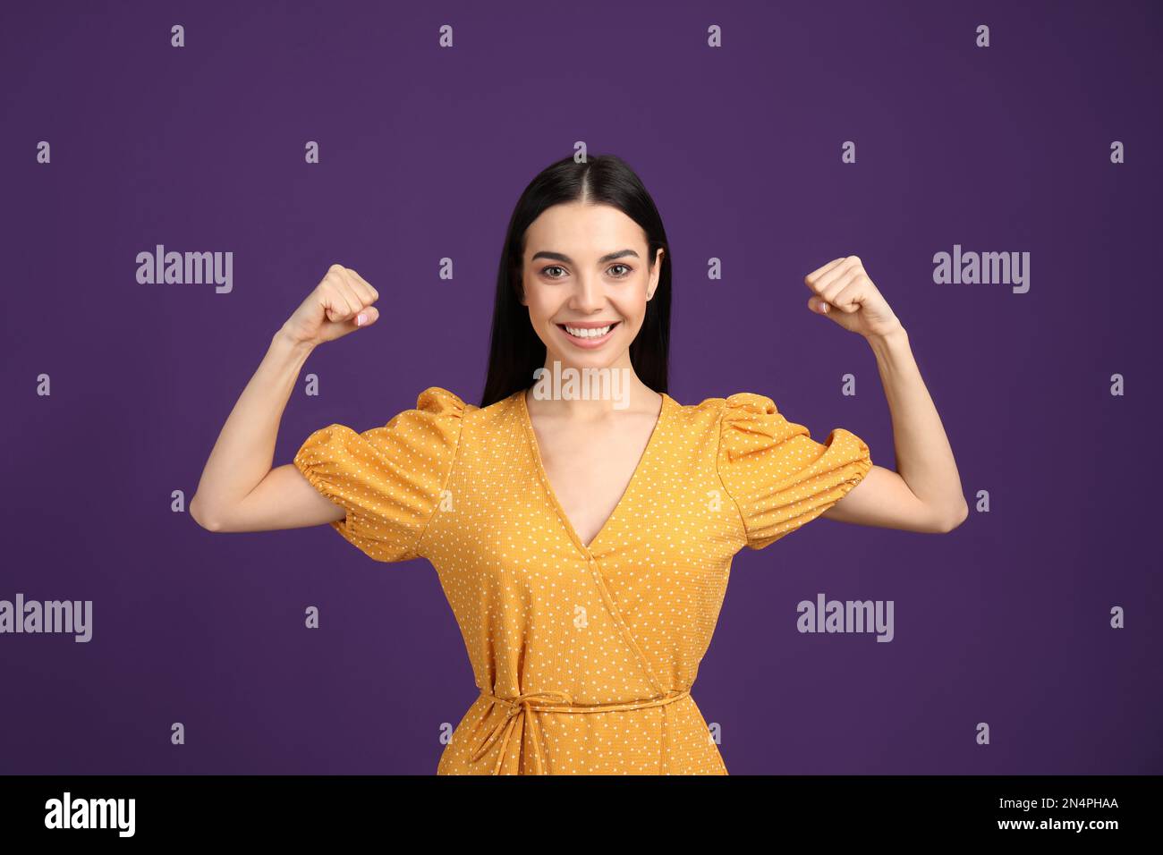 Strong woman as symbol of girl power on purple background. 8 March ...