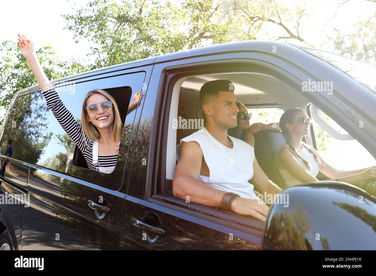 Happy friends together in car on road trip Stock Photo - Alamy