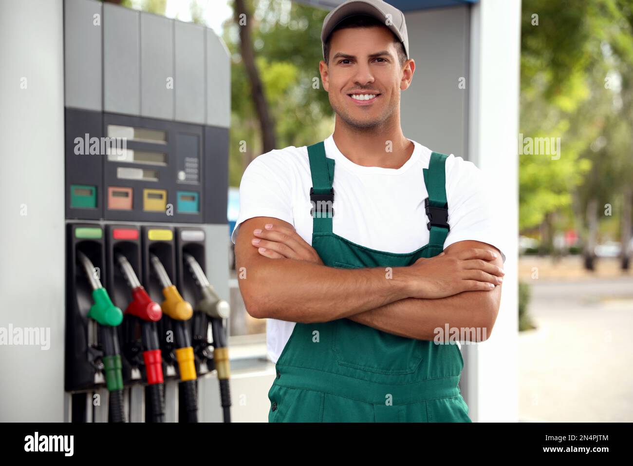 Worker in uniform at modern gas station Stock Photo - Alamy