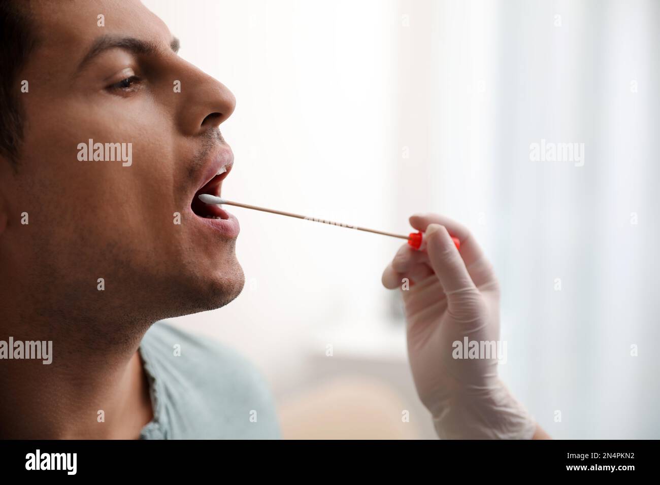 Doctor taking sample for DNA test from man in clinic Stock Photo - Alamy
