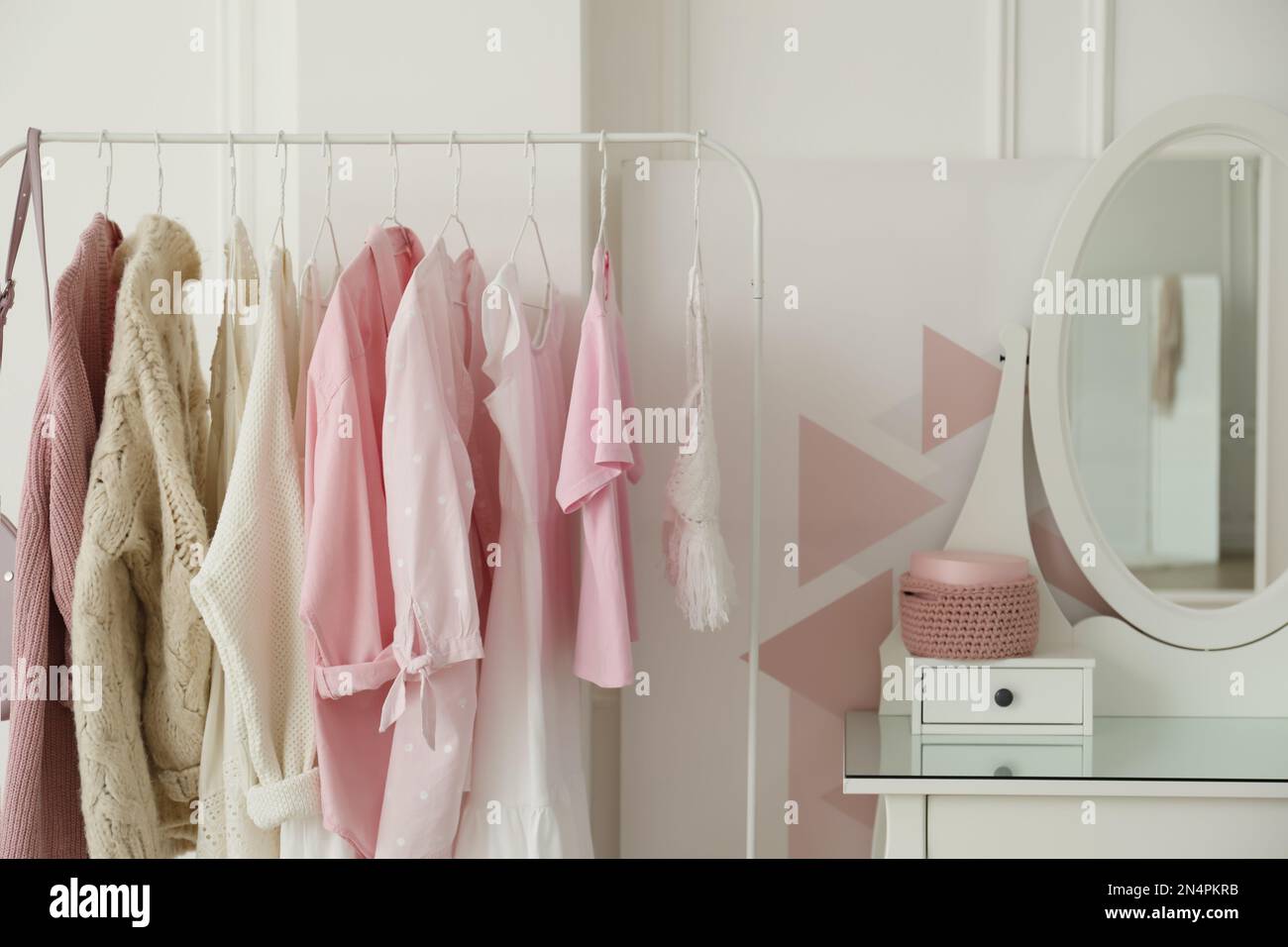 Dressing room interior with clothing rack and round mirror Stock Photo ...