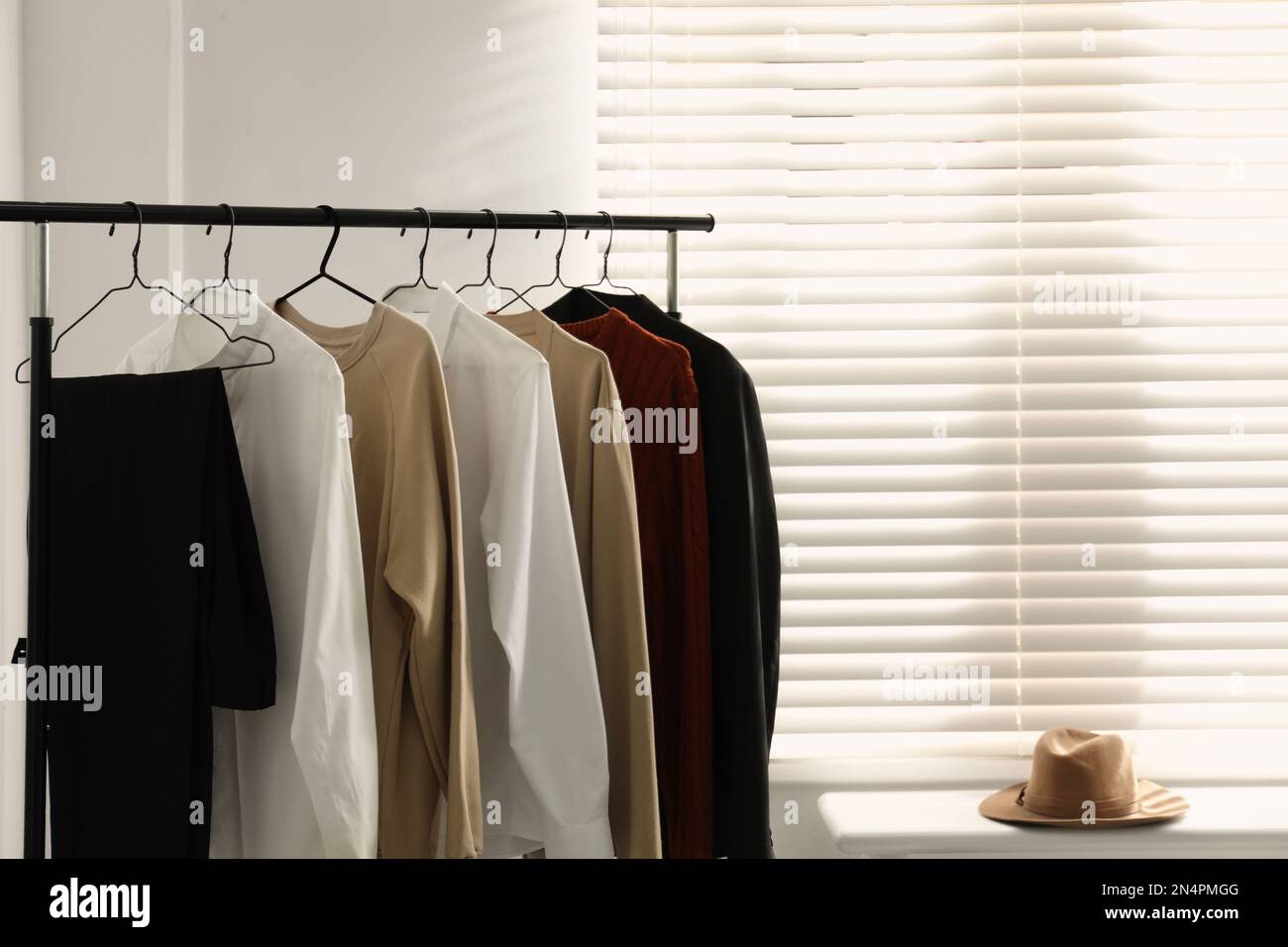 Rack with stylish men's clothes indoors. Interior design Stock Photo ...