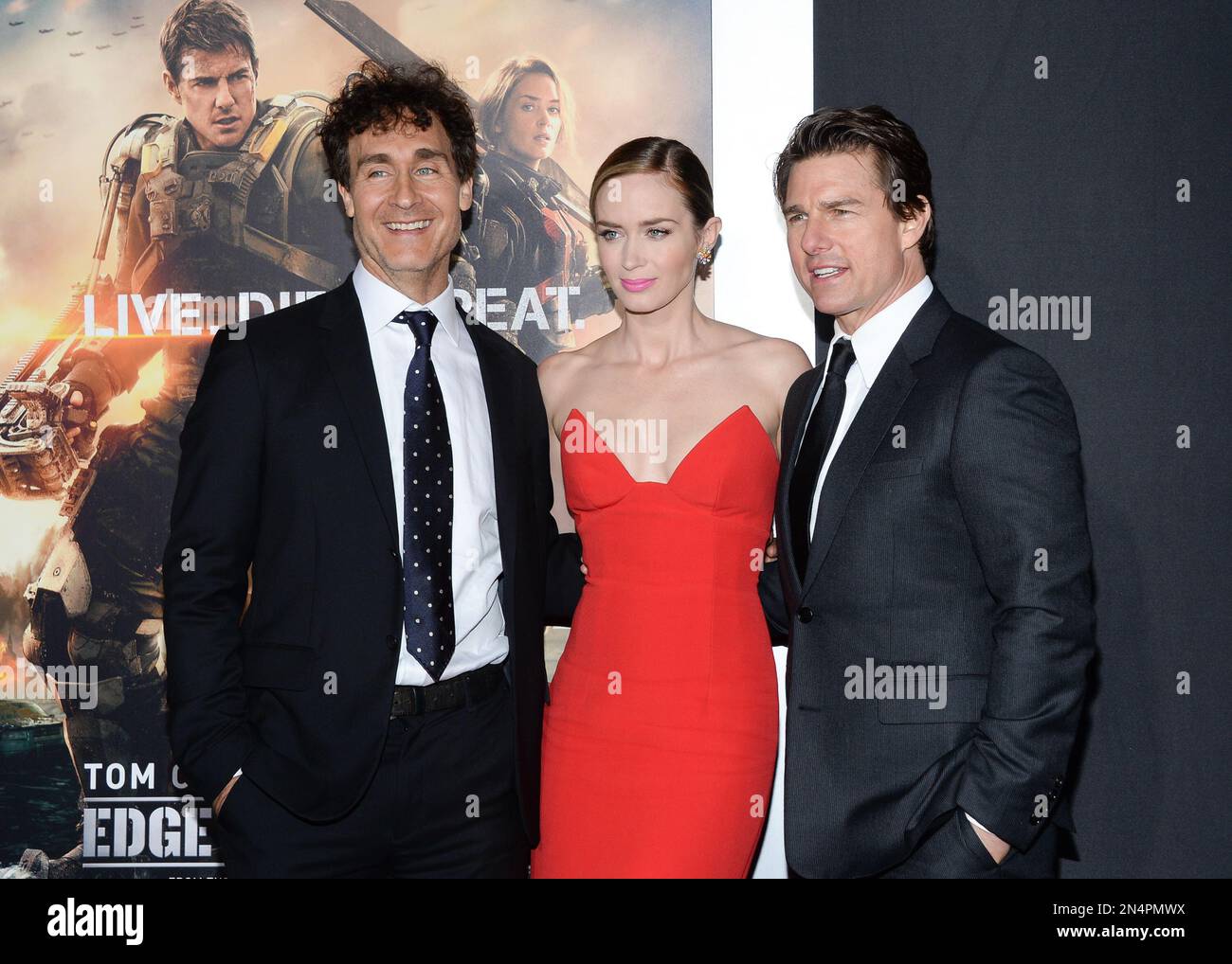 Director Doug Liman, left, poses with actors Emily Blunt and Tom Cruise ...