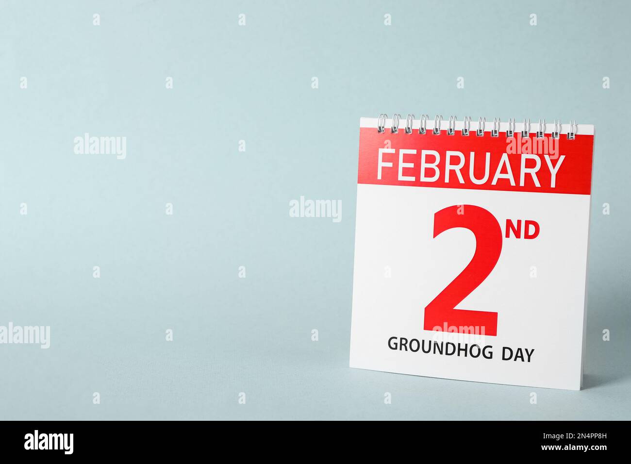 Calendar with date February 2nd on light background, space for text ...