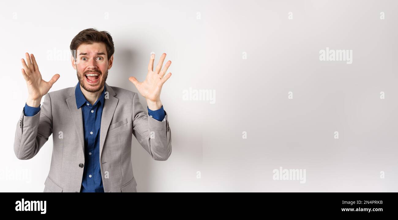 Businessman scream and shake hands in panic, look alarmed and anxious ...