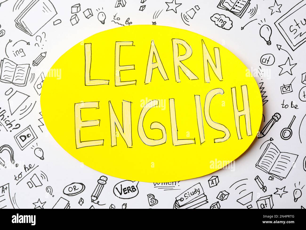 Note with phrase Learn English and drawings on white background, top ...
