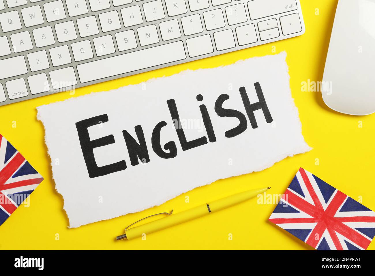 Paper with word English, keyboard, mouse and UK flags on yellow ...