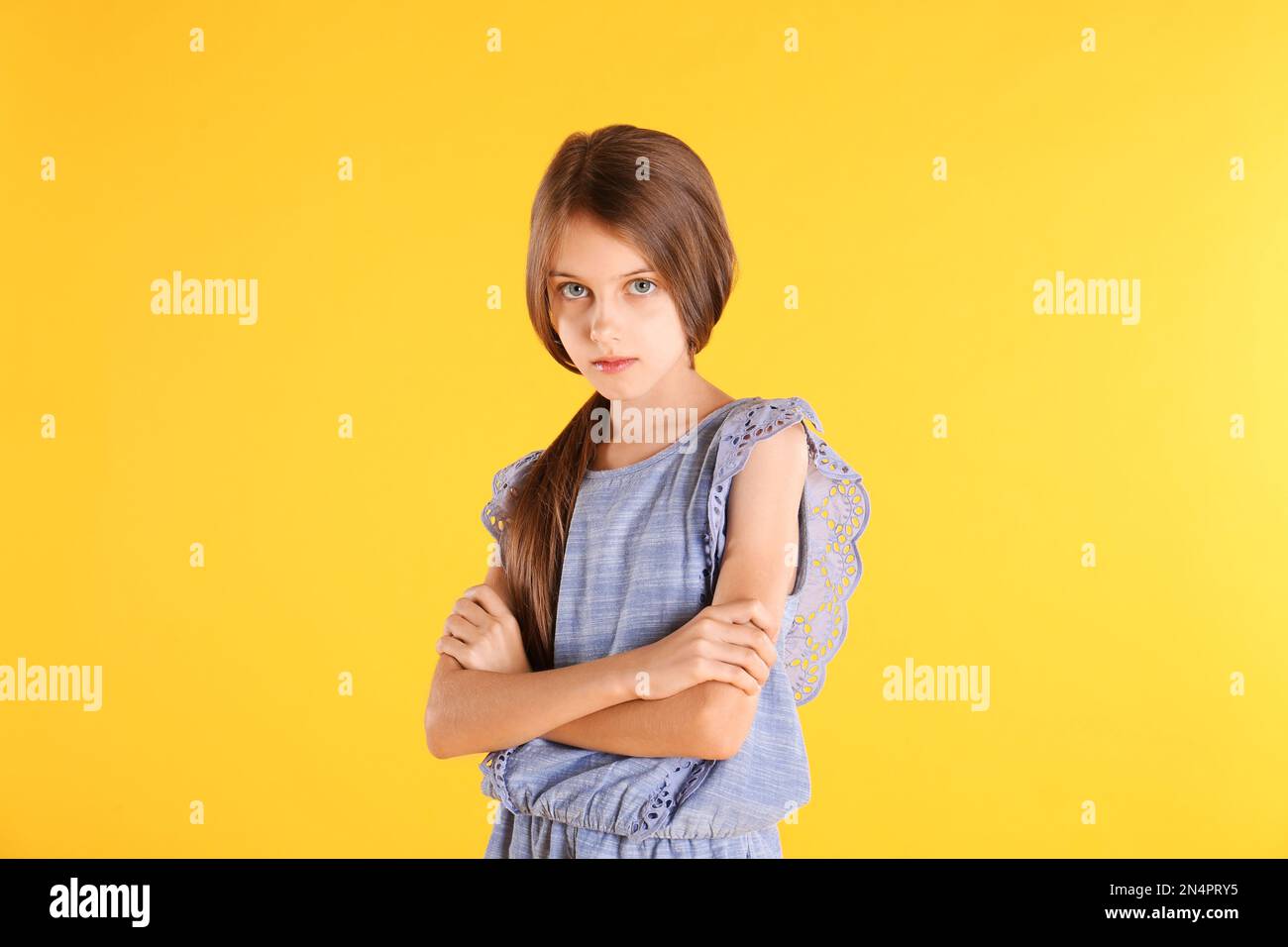 Portrait of cute little girl on yellow background Stock Photo - Alamy