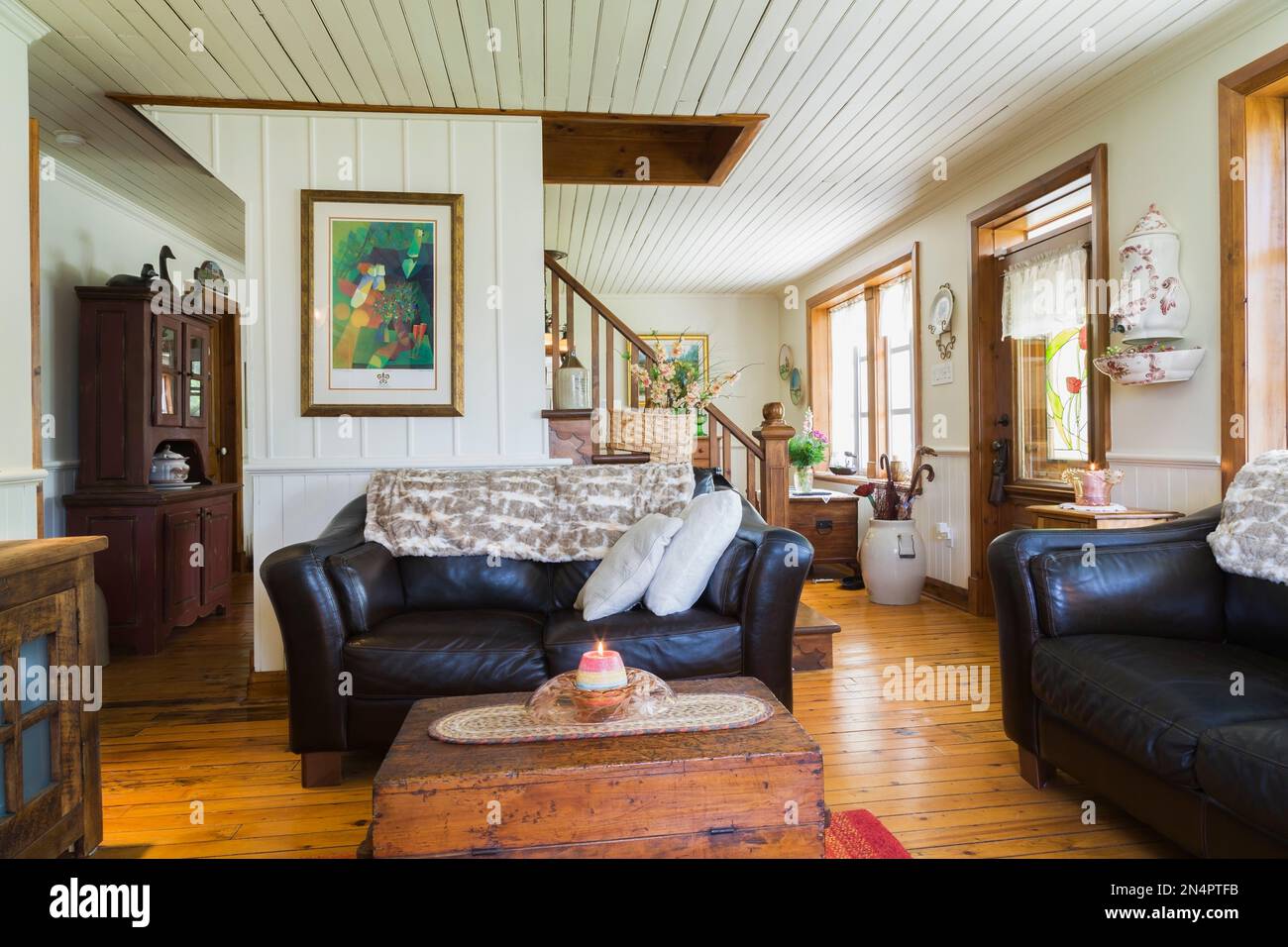Dark brown leather sofas and wooden chest table in living room inside ...