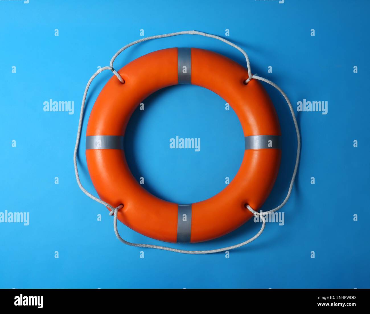 Orange lifebuoy on blue background. Rescue equipment Stock Photo - Alamy