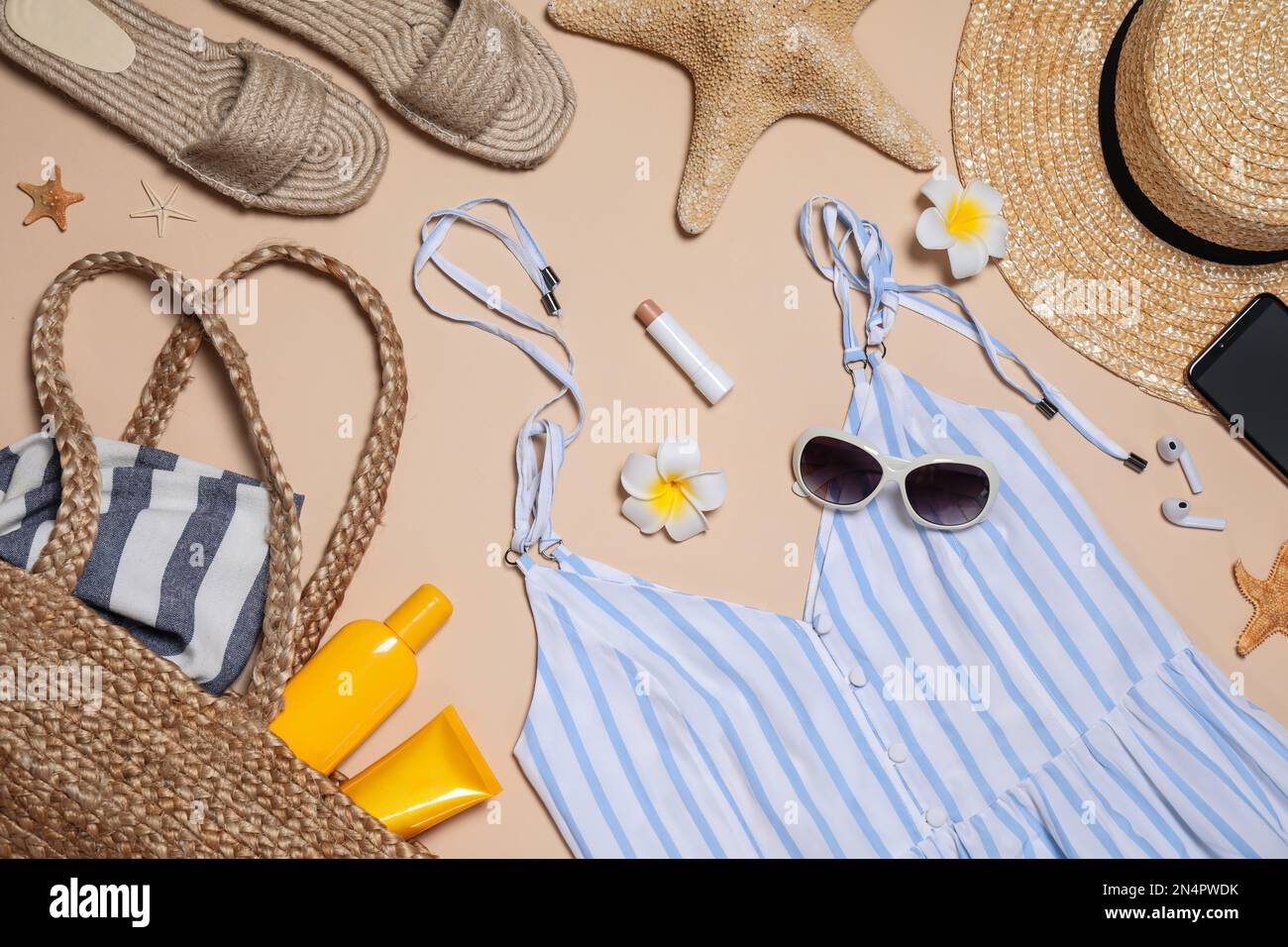 Beach accessories on beige background, flat lay Stock Photo - Alamy