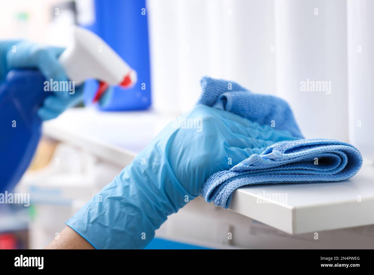 Woman cleaning shelf with rag and detergent in store, closeup Stock ...